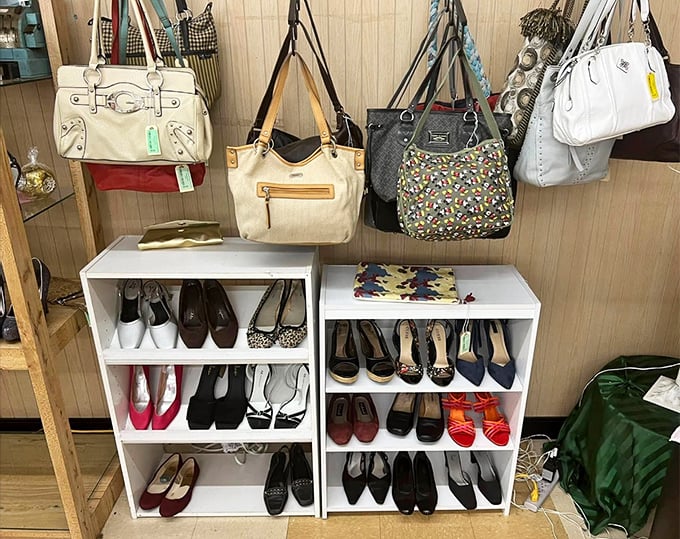 The accessories corner—where designer bags hang like ripe fruit above shelves of shoes that have stories to tell but secrets to keep.