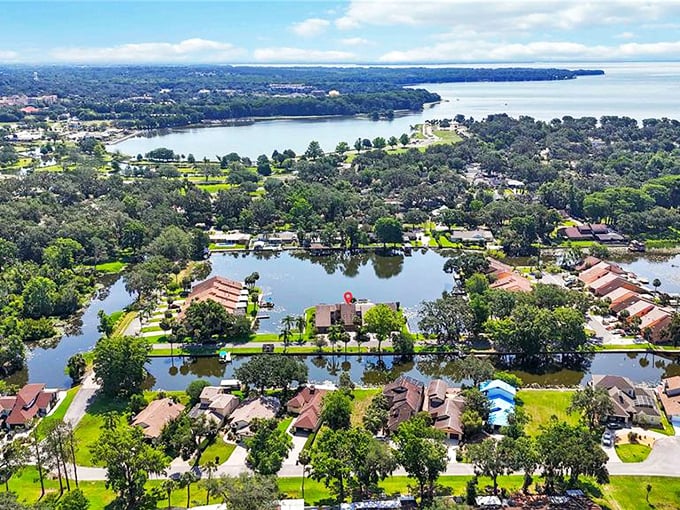 This aerial view reveals Leesburg's true character—a tapestry of blue waters, green canopy, and neighborhoods designed for living rather than just existing.