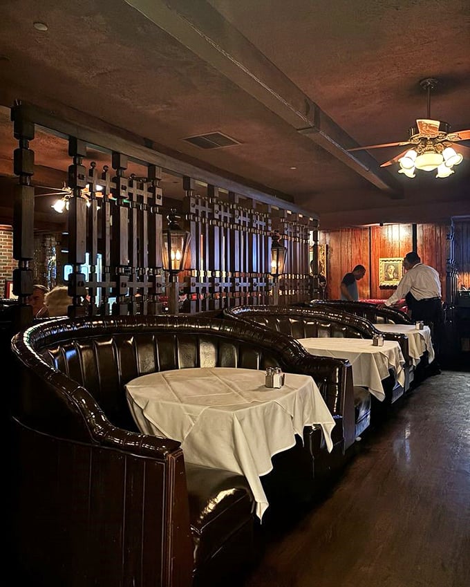 These curved booths aren't just seating—they're conversation cocoons where deals are made, anniversaries celebrated, and diet plans temporarily suspended.