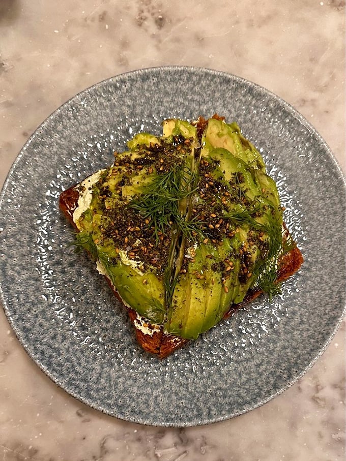 This isn't just avocado toast—it's a canvas of creamy green adorned with za'atar, dill, and other Middle Eastern flourishes that elevate breakfast to an art form.