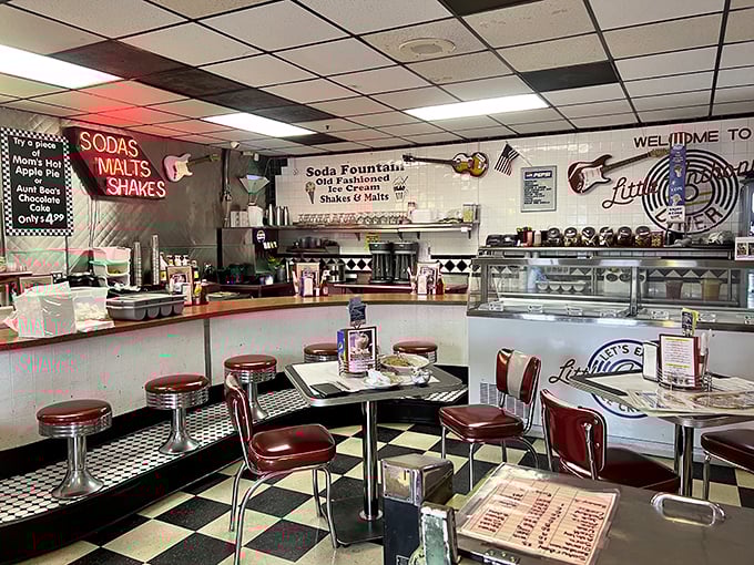 The soda fountain counter with its gleaming chrome and red vinyl stools isn't just seating—it's the best spot to watch short-order choreography while contemplating adult milkshakes.