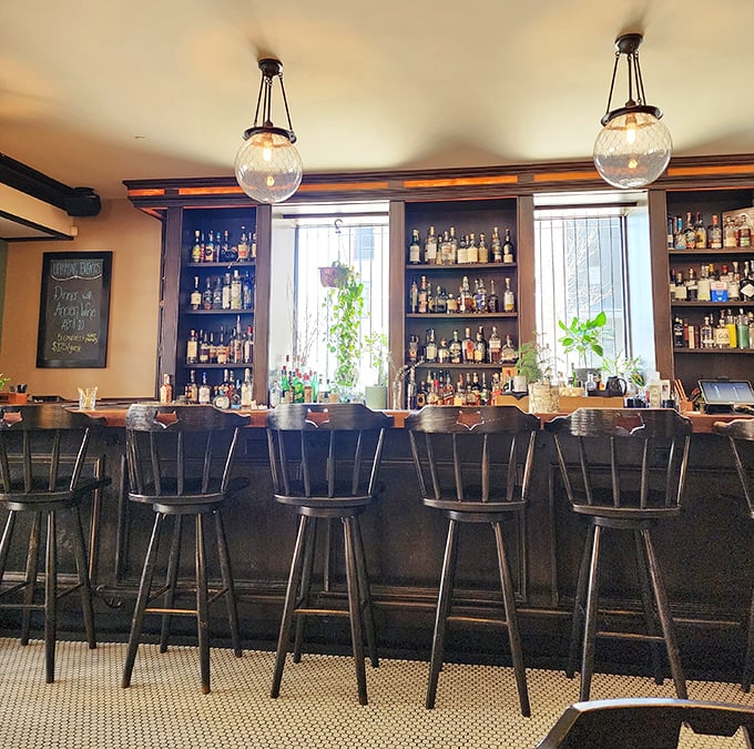 The bar at Heritage Tavern isn't just where drinks are served—it's where Madison's cocktail dreams come true under globe lights and careful hands.