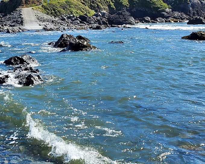 Turquoise waters crash against ancient rocks in a timeless performance that no retirement community pool could ever hope to match.