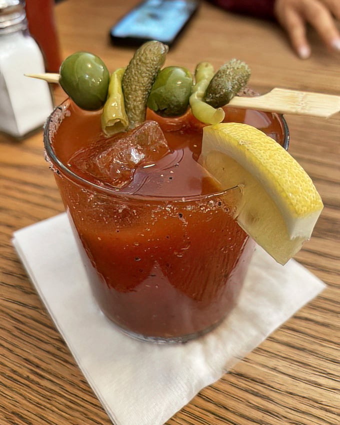 That Bloody Mary comes dressed to impress, with enough garnish to qualify as a salad course.