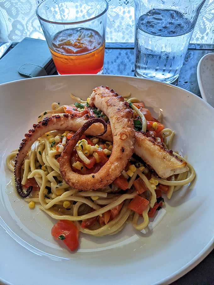 This bucatini with octopus is a masterclass in texture—tender tentacles meet al dente pasta in a summer vegetable symphony.