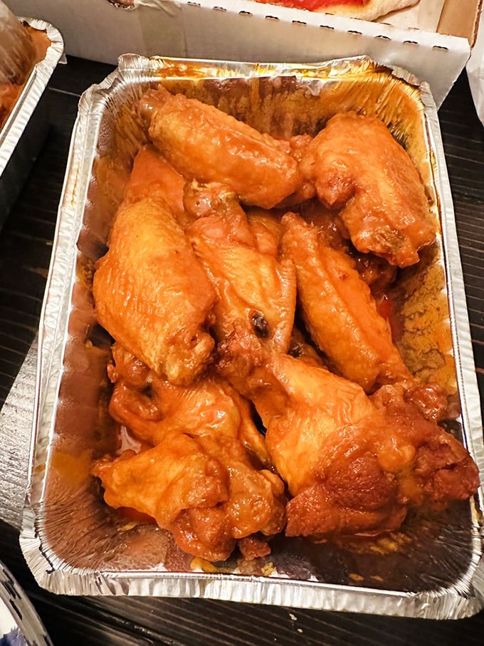 Buffalo wings glowing with that distinctive orange hue—nature's warning sign that says "delicious heat ahead." Your taste buds are about to tango.