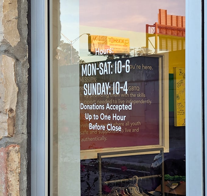 Hours posted clearly—a thrifter's roadmap to success. The golden sunset reflection seems to say, "Come back tomorrow for a whole new inventory adventure."