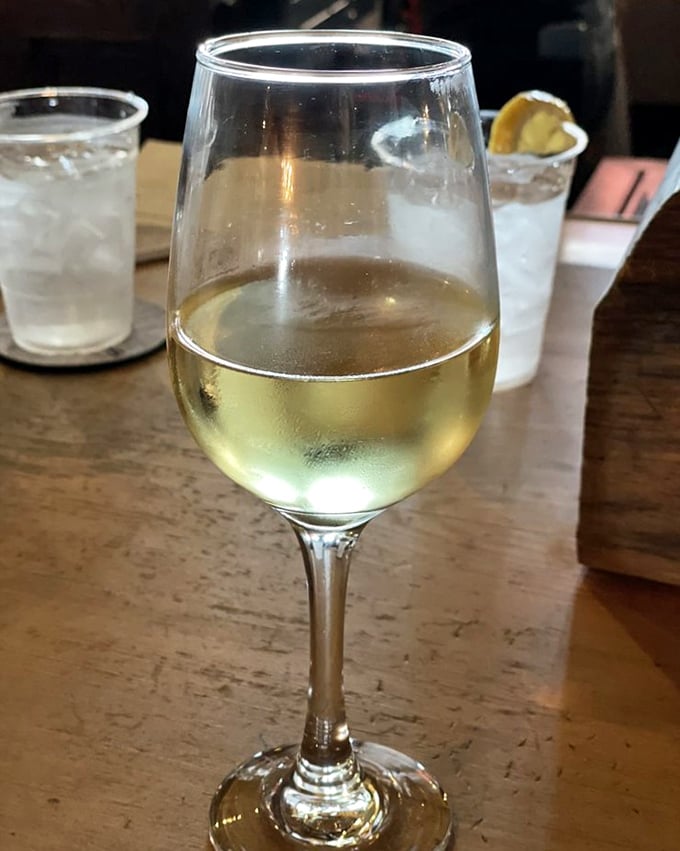 A glass of chilled white wine—the perfect supporting actor in your seafood symphony, never stealing the scene but enhancing every bite.