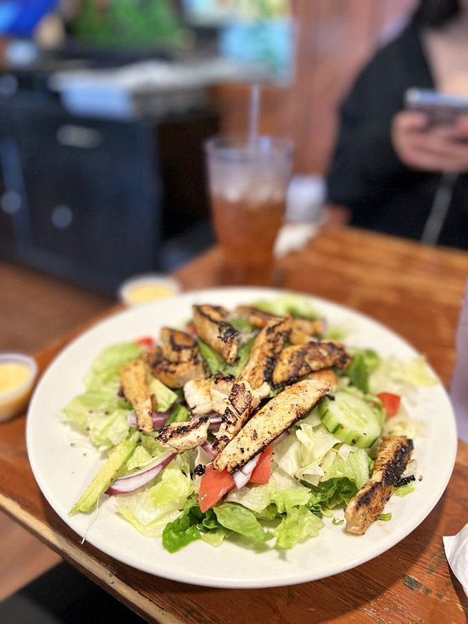 A grilled chicken salad that somehow manages to make lettuce exciting—the culinary equivalent of making sensible shoes look fashionable.
