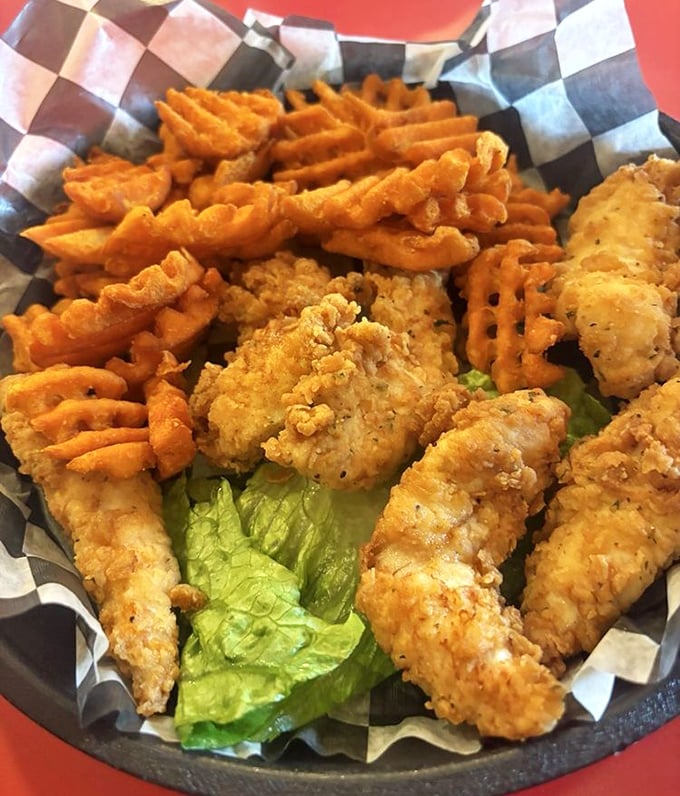 Crispy chicken tenders and waffle fries—proof that sometimes the simplest pleasures are the most profound, especially when the breading is this perfect.