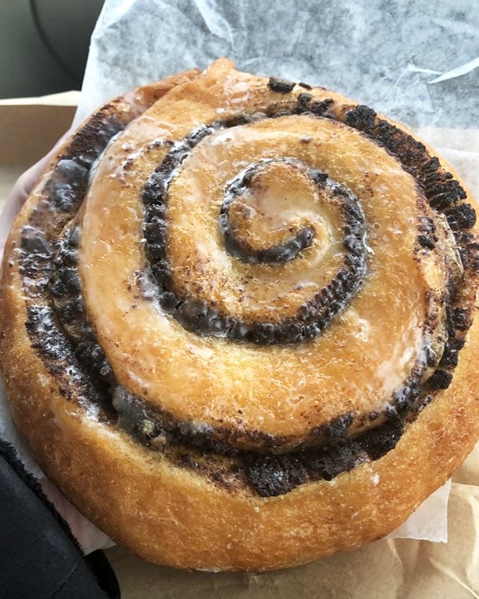 The cinnamon roll—a spiral galaxy of buttery dough and spice. Its gravitational pull is impossible to resist, drawing you into its sweet orbit.