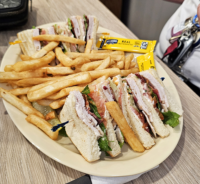 The club sandwich—architectural marvel of the lunch menu. Three layers of bread supporting the weight of expectations and delivering on every promise.