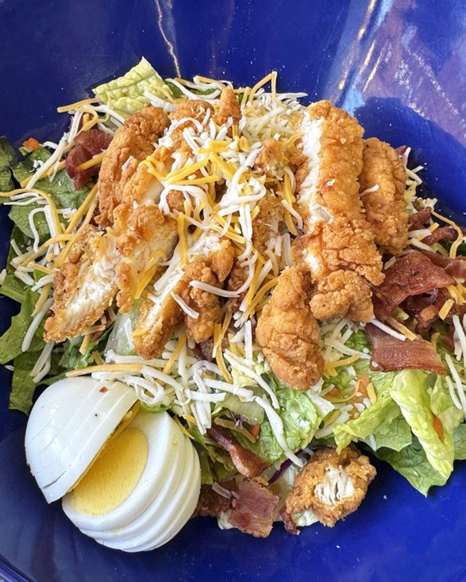 A Cobb salad that understands the assignment—crispy chicken, generous bacon, and perfect hard-boiled egg arranged like edible art.