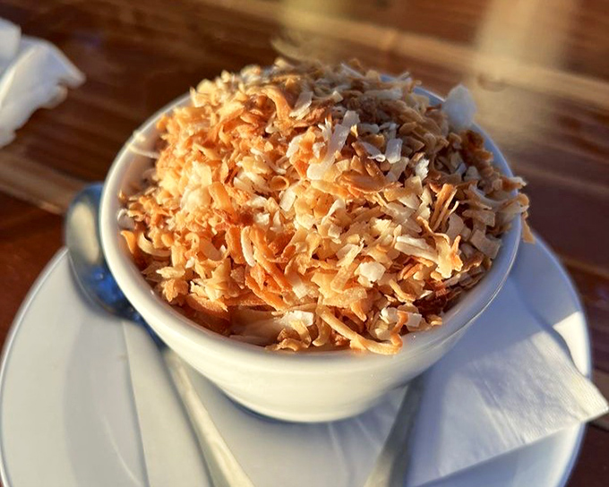 Coconut cake that's light as air but rich as Midas. The toasted coconut on top isn't decoration—it's the crown this royal dessert deserves. 
