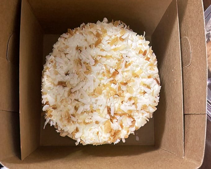 This coconut cake in its humble box is the dessert equivalent of Clark Kent – unassuming packaging hiding something truly super inside.
