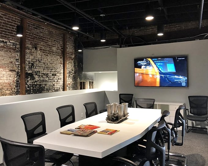 Beyond the showroom, the museum's conference space blends industrial brick with modern amenities—where car clubs and enthusiasts gather to share their mechanical passions.