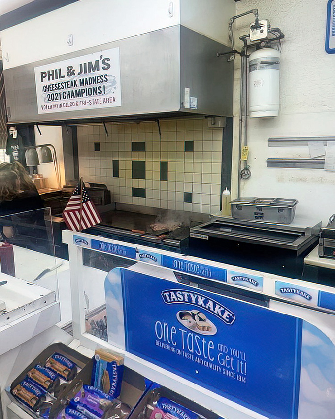 Behind the scenes where champions are made. That "2021 Cheesesteak Madness Champions" sign isn't just decoration—it's a well-earned trophy.