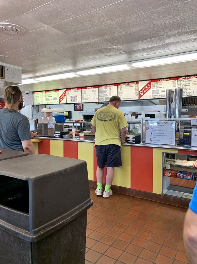 At the counter, where chicken dreams come true, customers wait patiently for treasures worth every minute of anticipation.