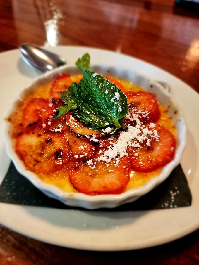 This crème brûlée isn't just dessert, it's edible sunshine – caramelized perfection topped with fresh berries and a mint leaf crown.