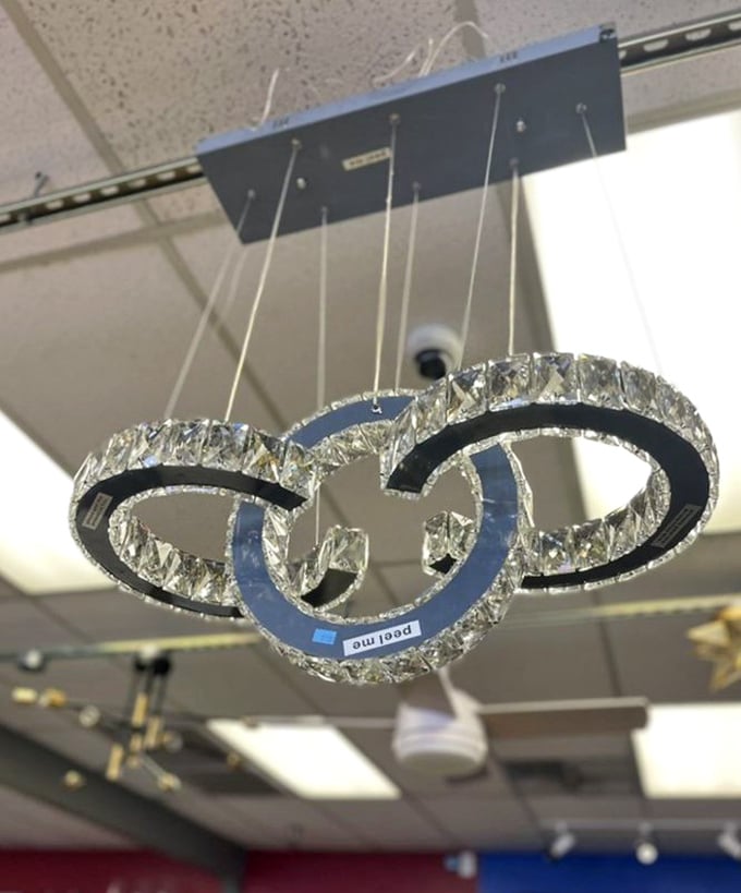 A crystal chandelier that probably illuminated someone's grand foyer now dangles with possibility—glamour at thrift store prices is the ultimate luxury.