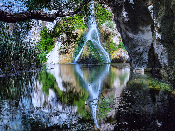 The falls create a mirror image on the still pool below—nature admiring itself like the rest of us checking our reflection in store windows.