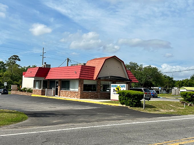 Dora Cafe's distinctive red roof signals classic diner comfort food—the kind of place where locals gather and visitors wish they were locals.