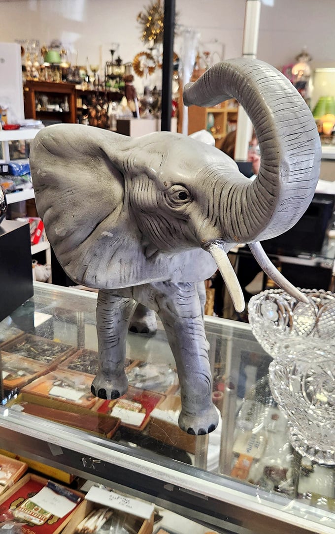 This elephant figurine has seen it all – trunk raised in eternal greeting to browsers who recognize that sometimes the perfect souvenir finds you.
