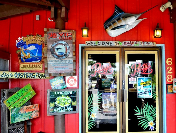 "The entrance to Rusty's promises a good time with its weathered red exterior and playful signage – Florida's seafood paradise awaits."