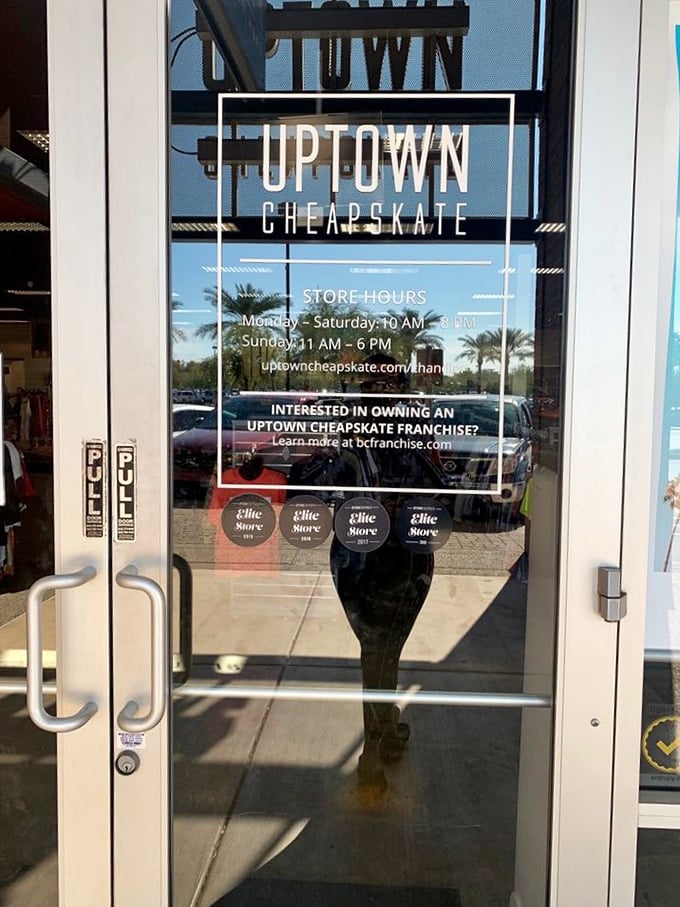 The gateway to greatness! Clear store hours and a reflection of palm trees promise an air-conditioned oasis of affordable fashion adventures inside.