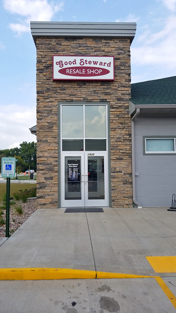 The welcoming entrance, with its professional signage and stone facade, promises a thrifting experience that defies expectations.