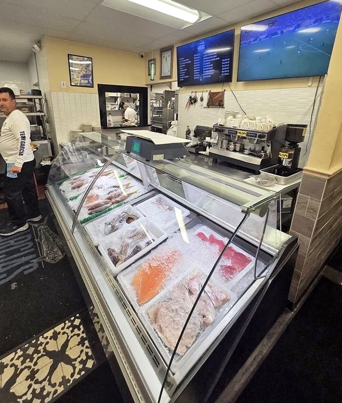 The fish market display case—where tomorrow's menu items rest on ice, eyes clear and gills bright, the ultimate freshness guarantee.