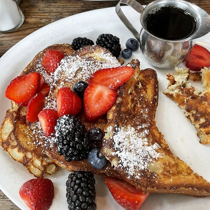 French toast that's having a berry good time. This isn't just breakfast—it's dessert that somehow got permission to be eaten before noon.