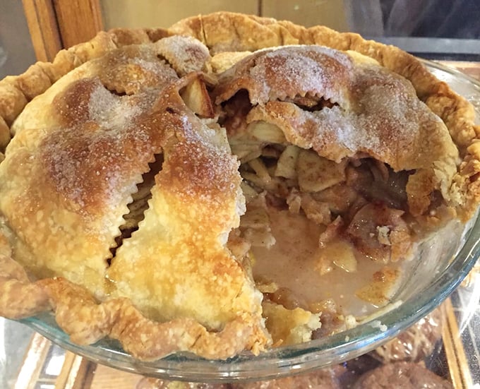 Apple pie with that telltale gap between filling and crust—proof that it's homemade by someone who understands the importance of dessert.