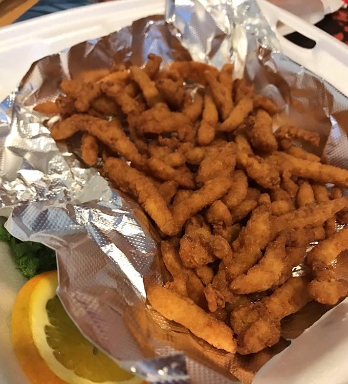 Fried clam strips that crunch like autumn leaves but taste like summer at the shore—pure nostalgic bliss.
