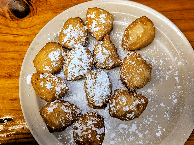 Funnel cake balls dusted with powdered sugar—proof that sometimes the best innovations are just beloved classics in a more poppable form.