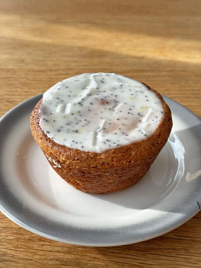 This lemon poppy seed muffin, with its perfect dome and glistening glaze, isn't just gluten-free – it's a tiny masterpiece of texture and bright citrus flavor.