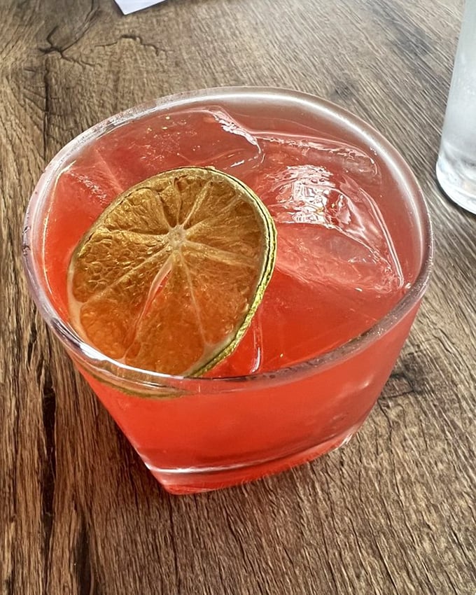 A cocktail that glows like a sunset, with that perfect lime wheel perched on the edge – one sip and you're transported somewhere tropical.
