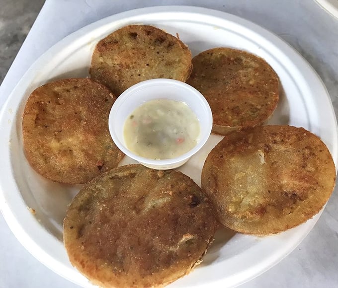 Fried green tomatoes – the South's gift to the culinary world – crispy, tangy discs of perfection with a dipping sauce that seals the deal.