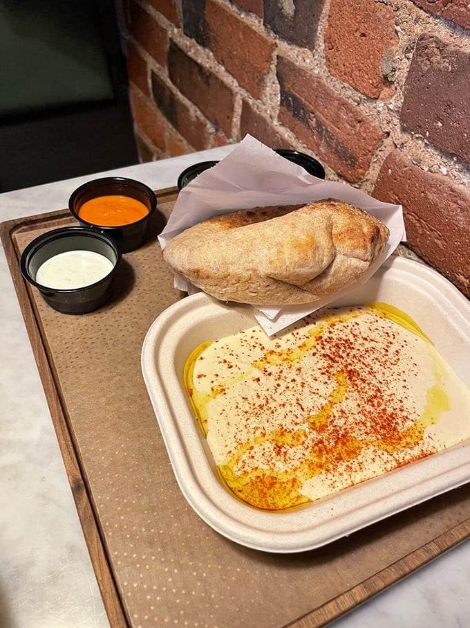 Hummus so silky it could moonlight as a cloud, drizzled with olive oil and dusted with spices—proof that simplicity, when done right, is the ultimate sophistication.