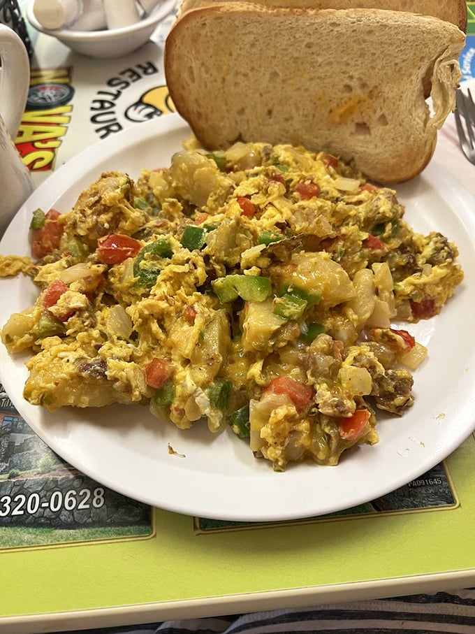 This scramble isn't just eggs – it's a colorful morning convention where vegetables and cheese have gathered to start your day right.