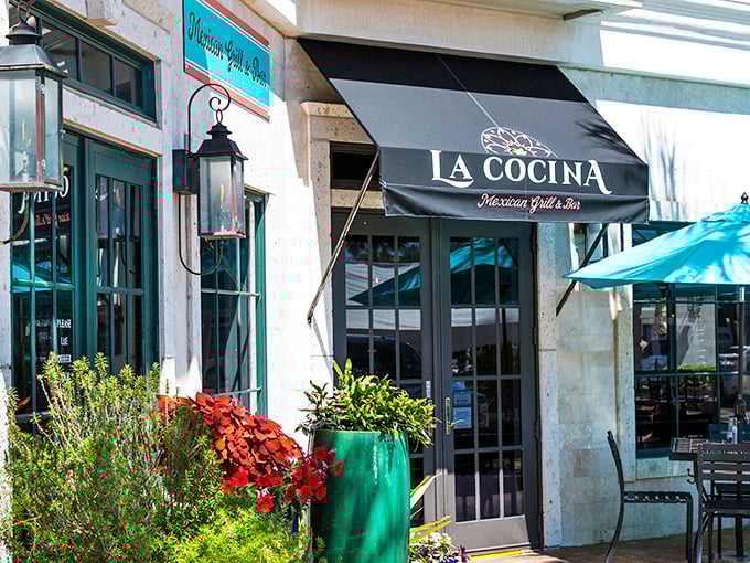 La Cocina's vibrant entrance, framed by colorful plantings, beckons with promises of margaritas and Mexican flavors that taste even better with Gulf breezes.