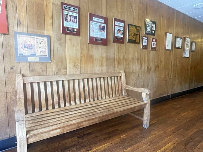 The wooden bench and framed memorabilia aren't calculated nostalgia—they're authentic artifacts from decades of serving the Pasadena community.