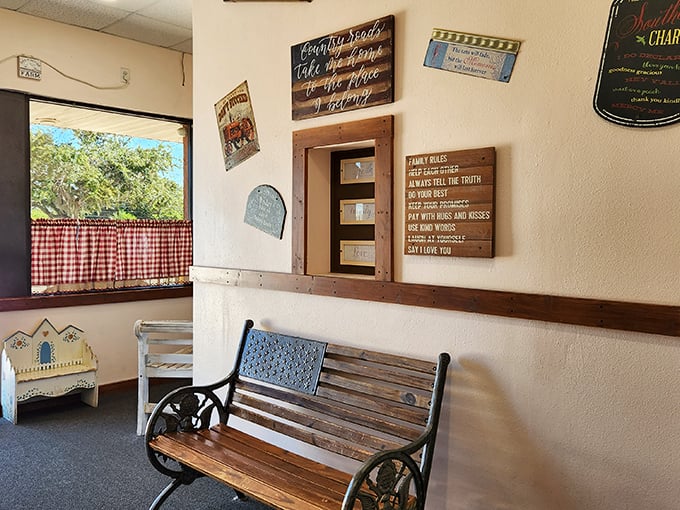 A waiting bench beneath family rules and red gingham curtains – the perfect spot to contemplate your upcoming breakfast decisions.