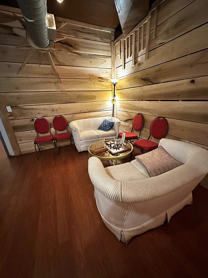 The hidden lounge area feels like discovering a secret room in your favorite novel – cozy, unexpected, and designed for lingering conversations.