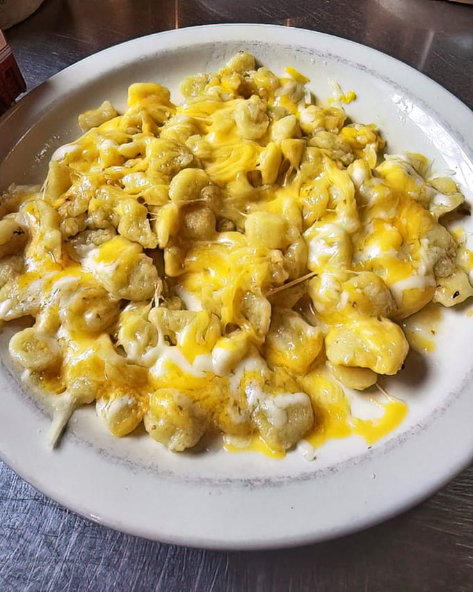 Mac and cheese that's having such a good time with itself, the noodles are throwing a party and everyone's wearing a cheese jacket.