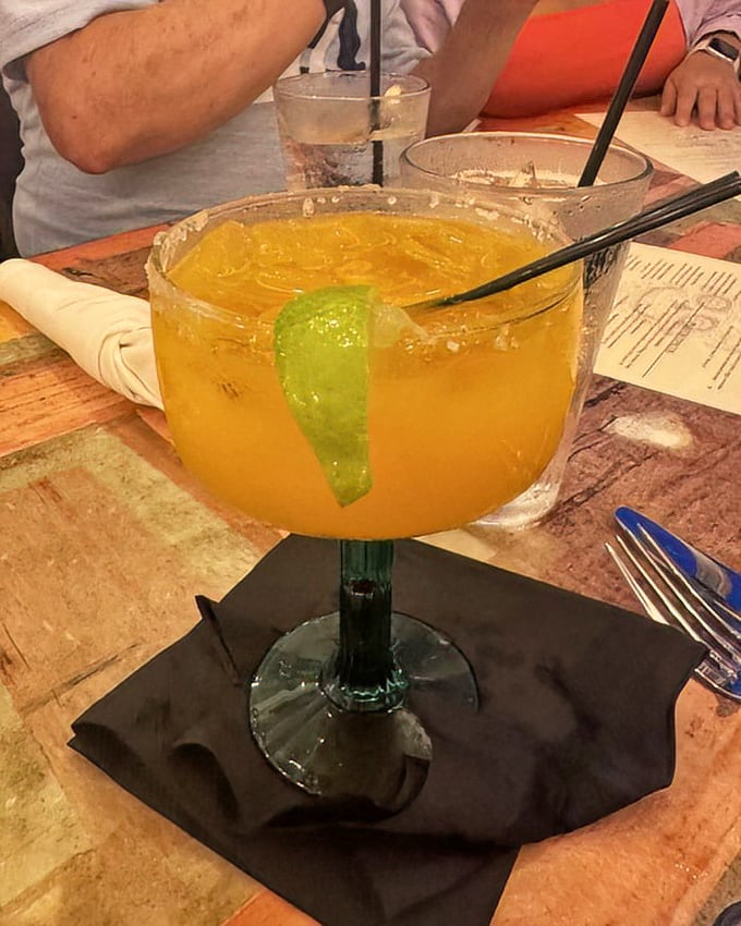 This mango margarita isn't just a drink, it's liquid vacation – sunshine in a glass with a lime wedge smile.