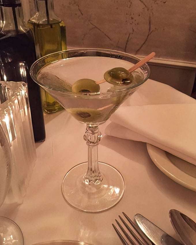 A classic martini with olives standing at attention—the James Bond of cocktails, sophisticated and dangerous in all the right ways.