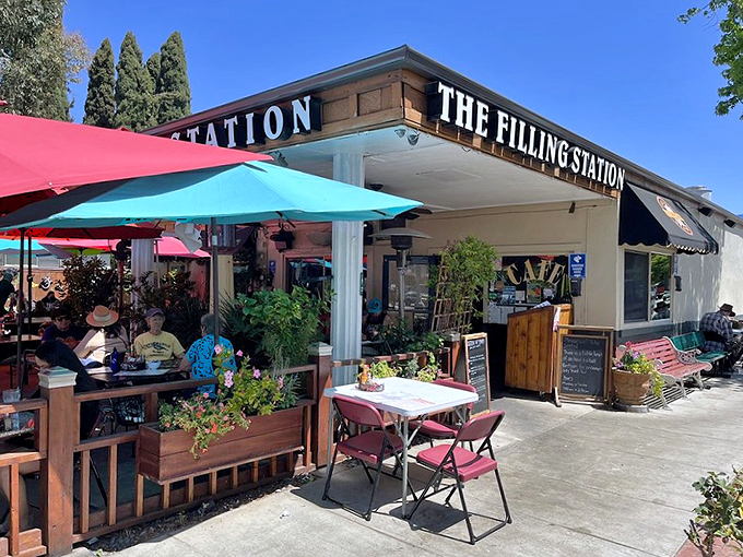 Morning sunshine bathes the cafe's exterior while diners claim their spots—early birds getting the ultimate breakfast worm.