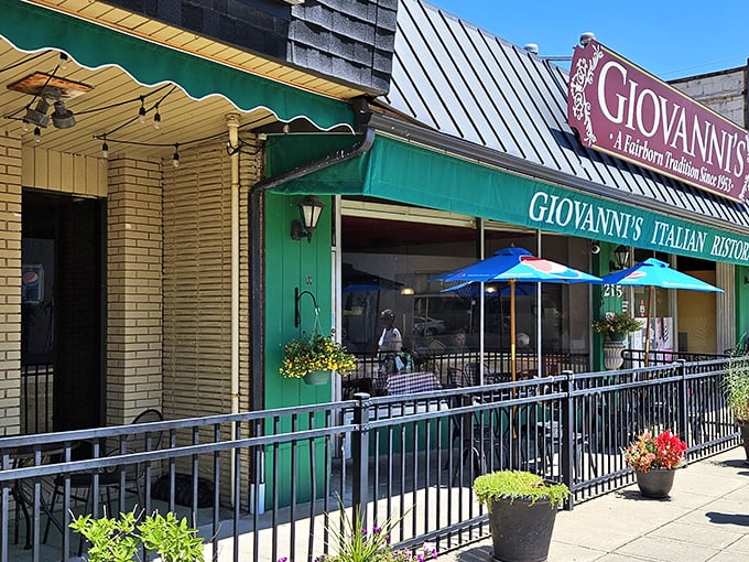 Blue umbrellas and flower pots add a touch of charm to the outdoor seating area. A little slice of sidewalk dining that comes alive in warmer months.