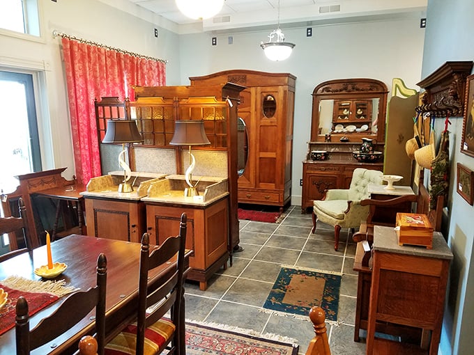 Warm lighting showcases dining furniture arranged as it might have been a century ago. These pieces aren't just for sale—they're auditioning for their next home.